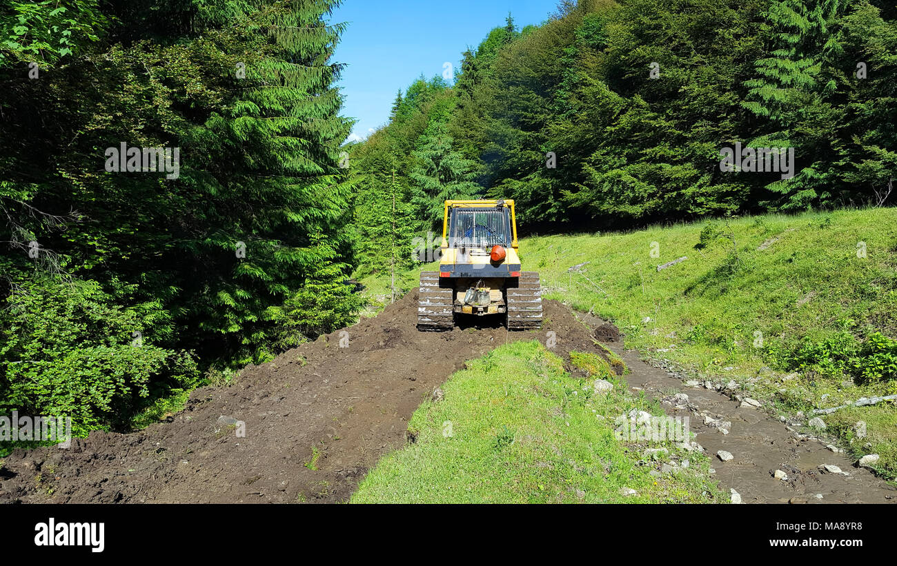 The bulldozer makes way in the forest Stock Photo - Alamy