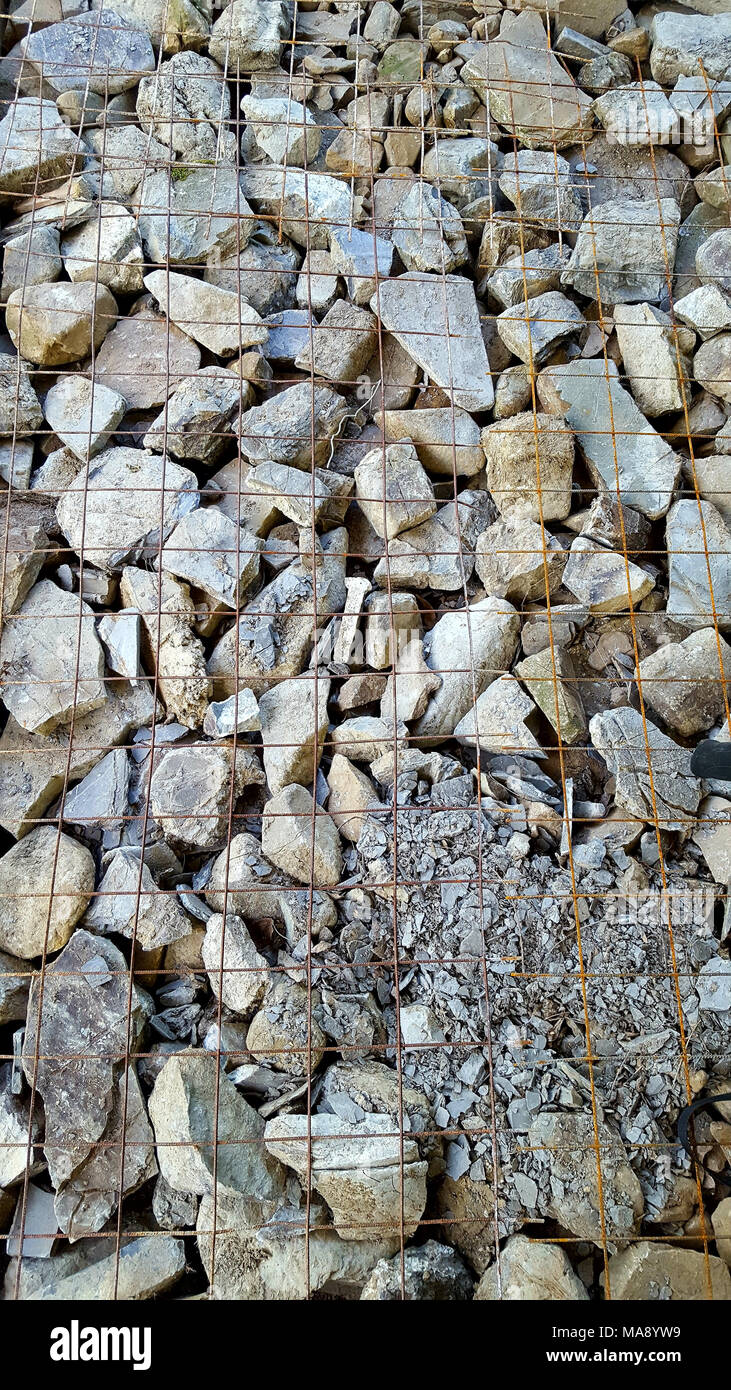 Metal grid laying and stone on construction area Stock Photo - Alamy