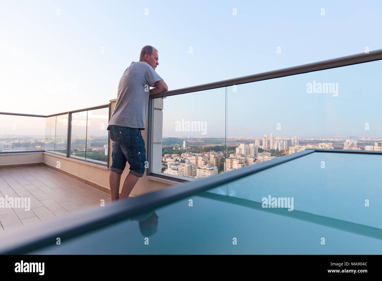Man glass balcony reflection hi-res stock photography and images - Alamy