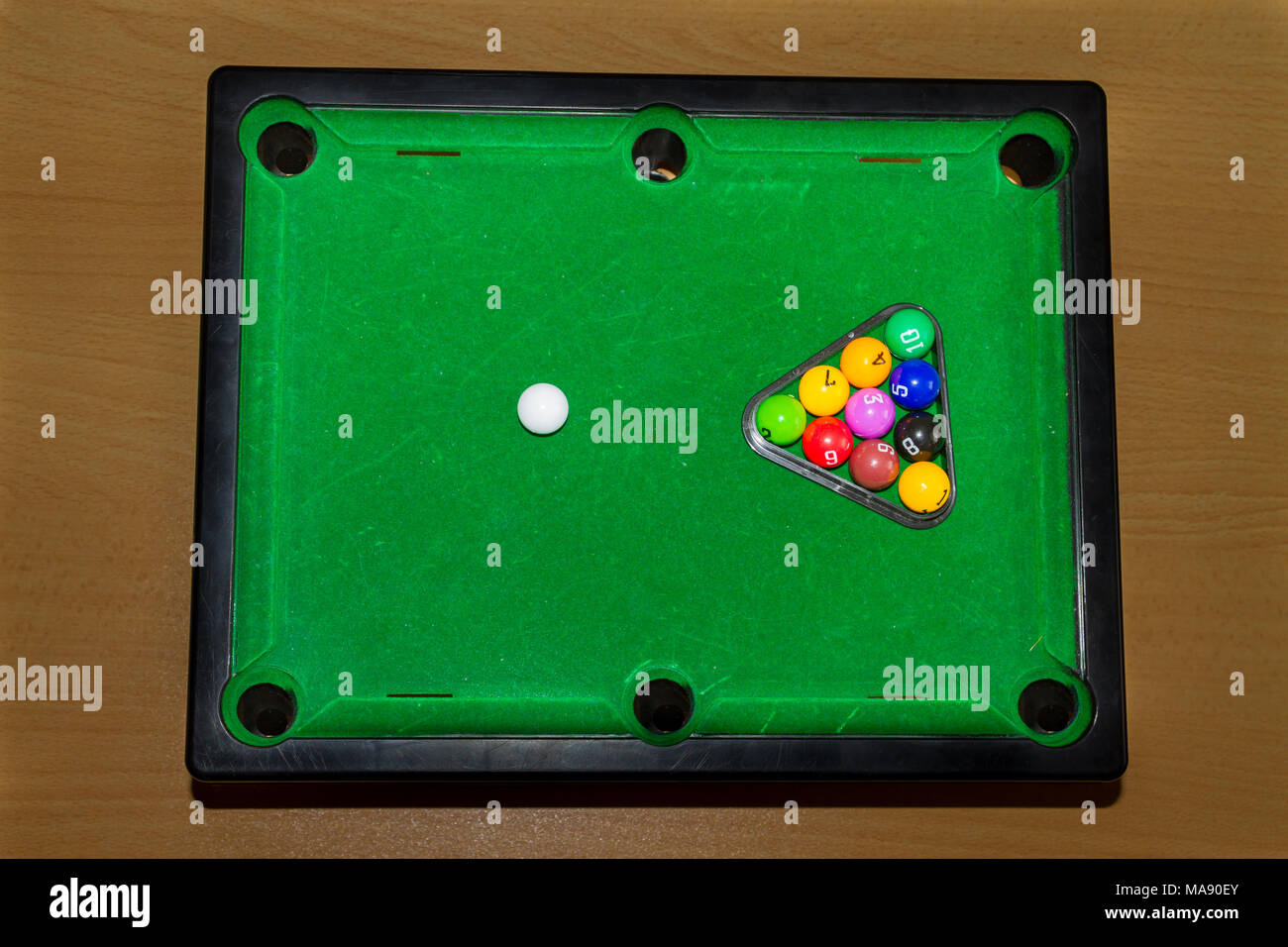 Children's pool table game with multicolored balls Stock Photo - Alamy