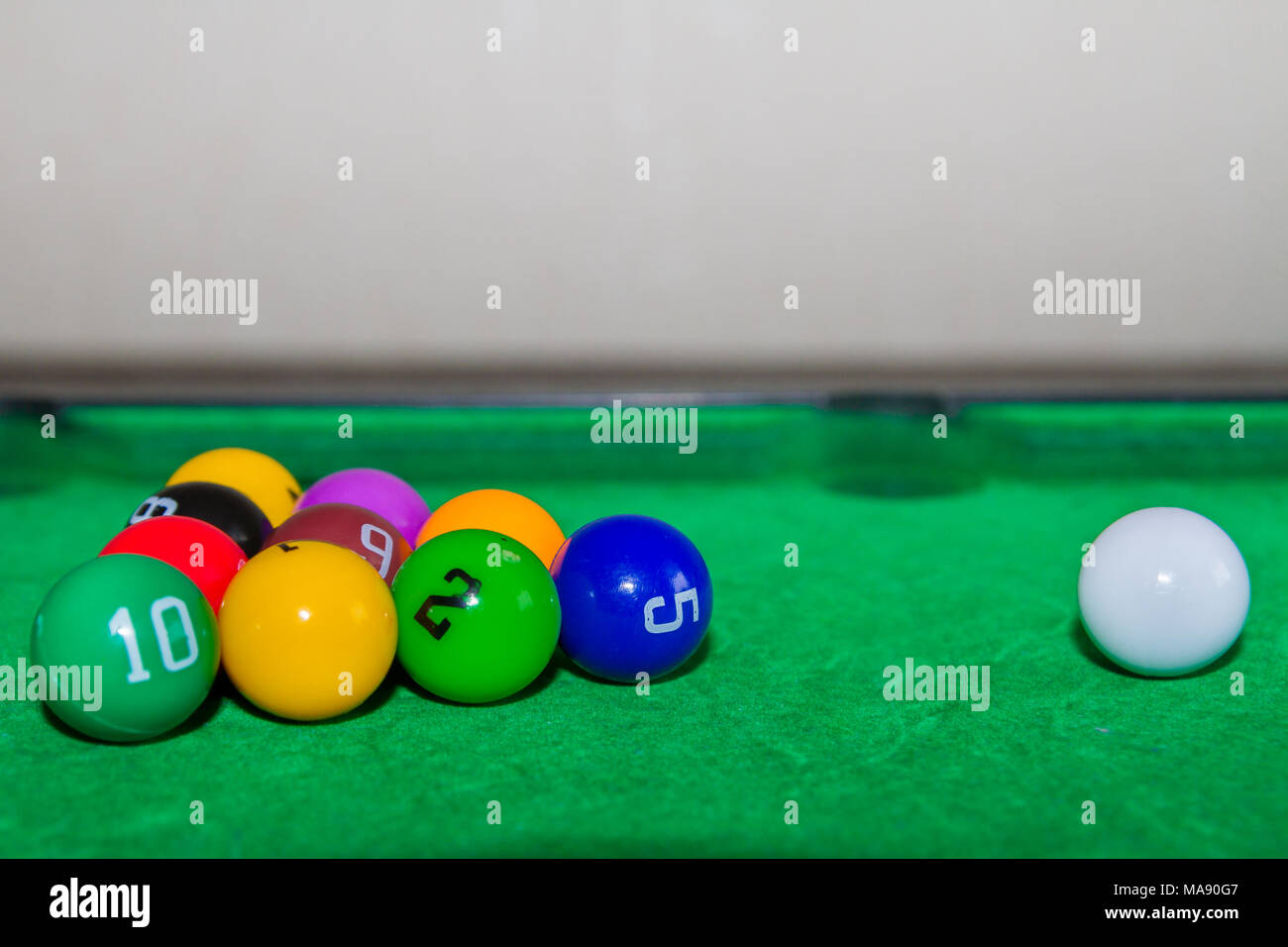 Children's pool table game with multicolored balls Stock Photo - Alamy