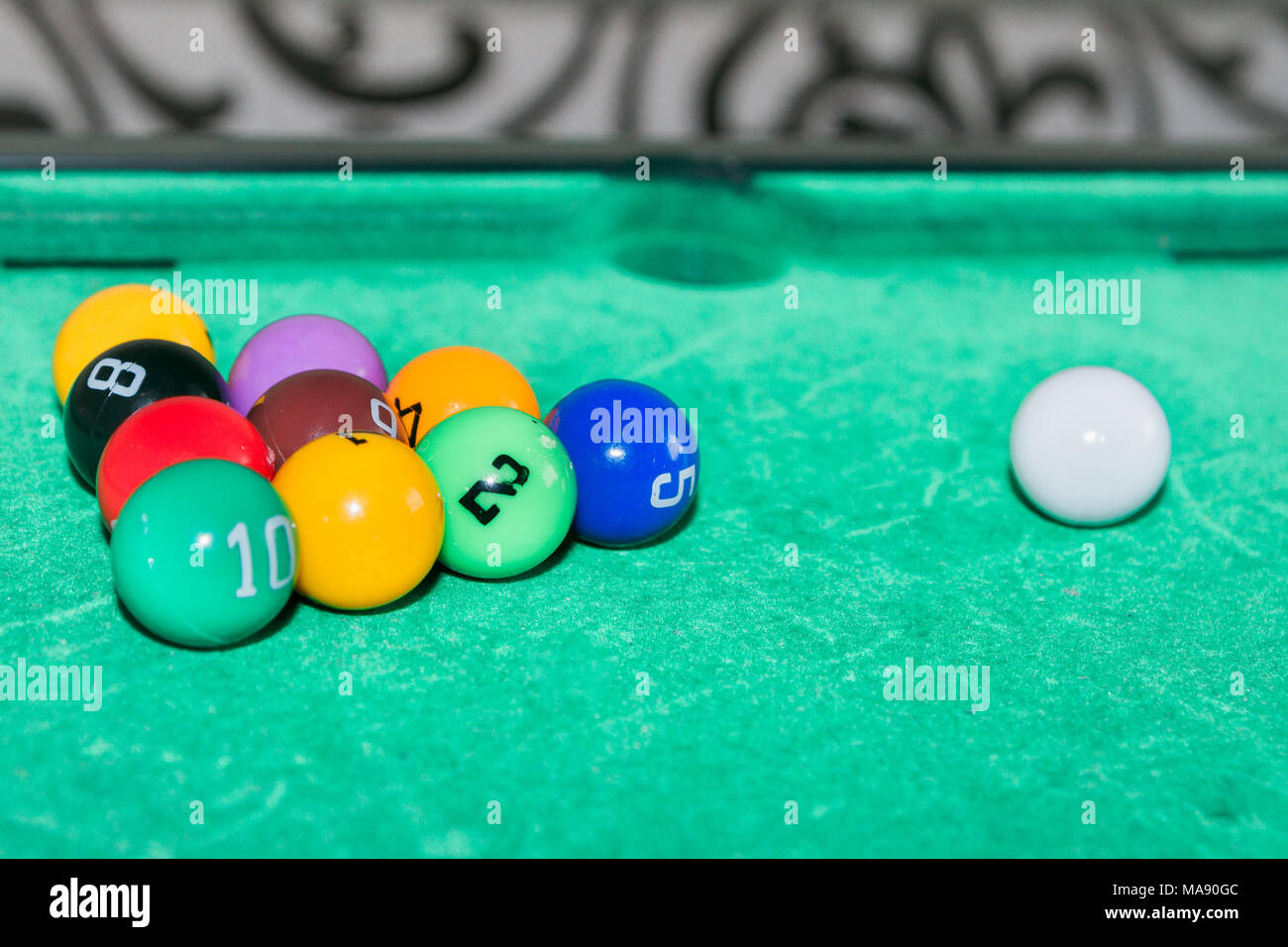 Children's pool table game with multicolored balls Stock Photo - Alamy