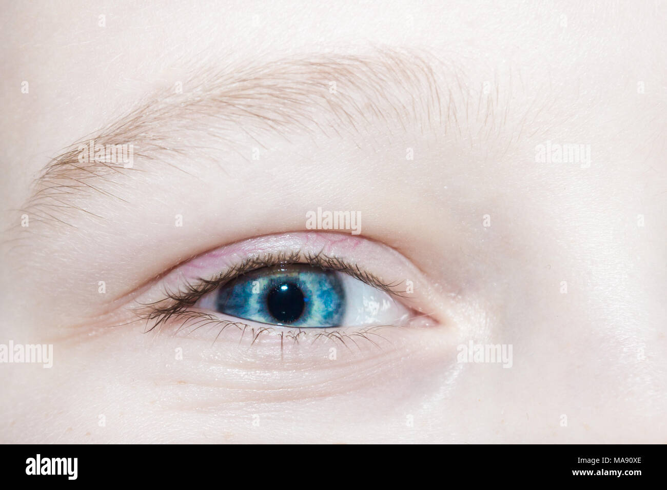 Baby blue beautiful, brooding eyes of a boy Stock Photo - Alamy