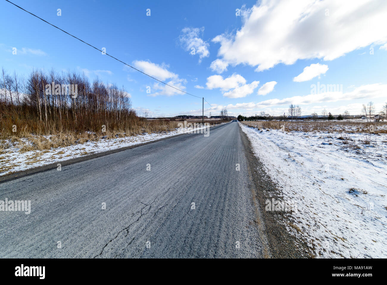 snowy winter road covered in deep snow with car tire tracks going in ...