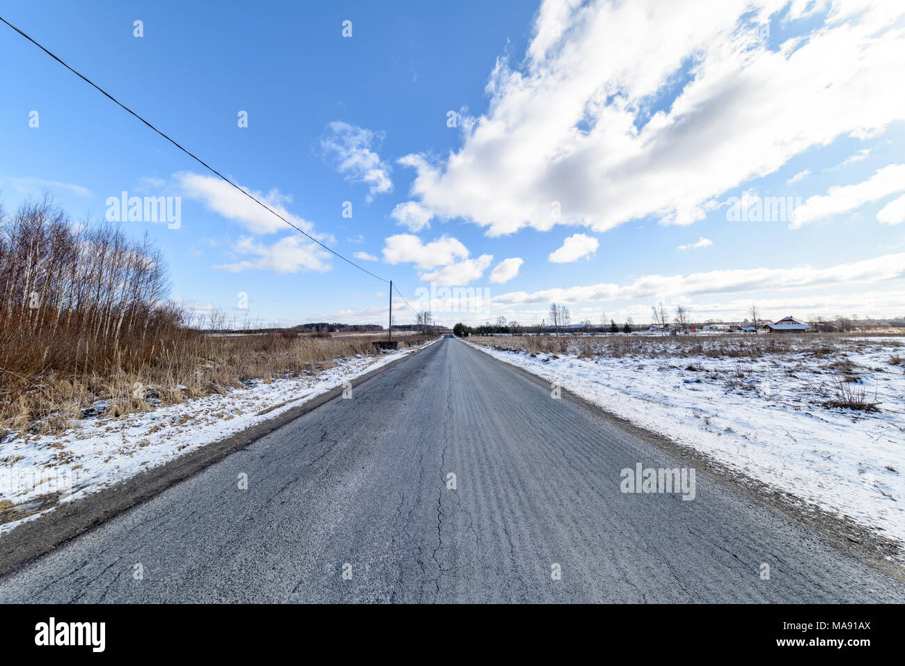 snowy winter road covered in deep snow with car tire tracks going in ...