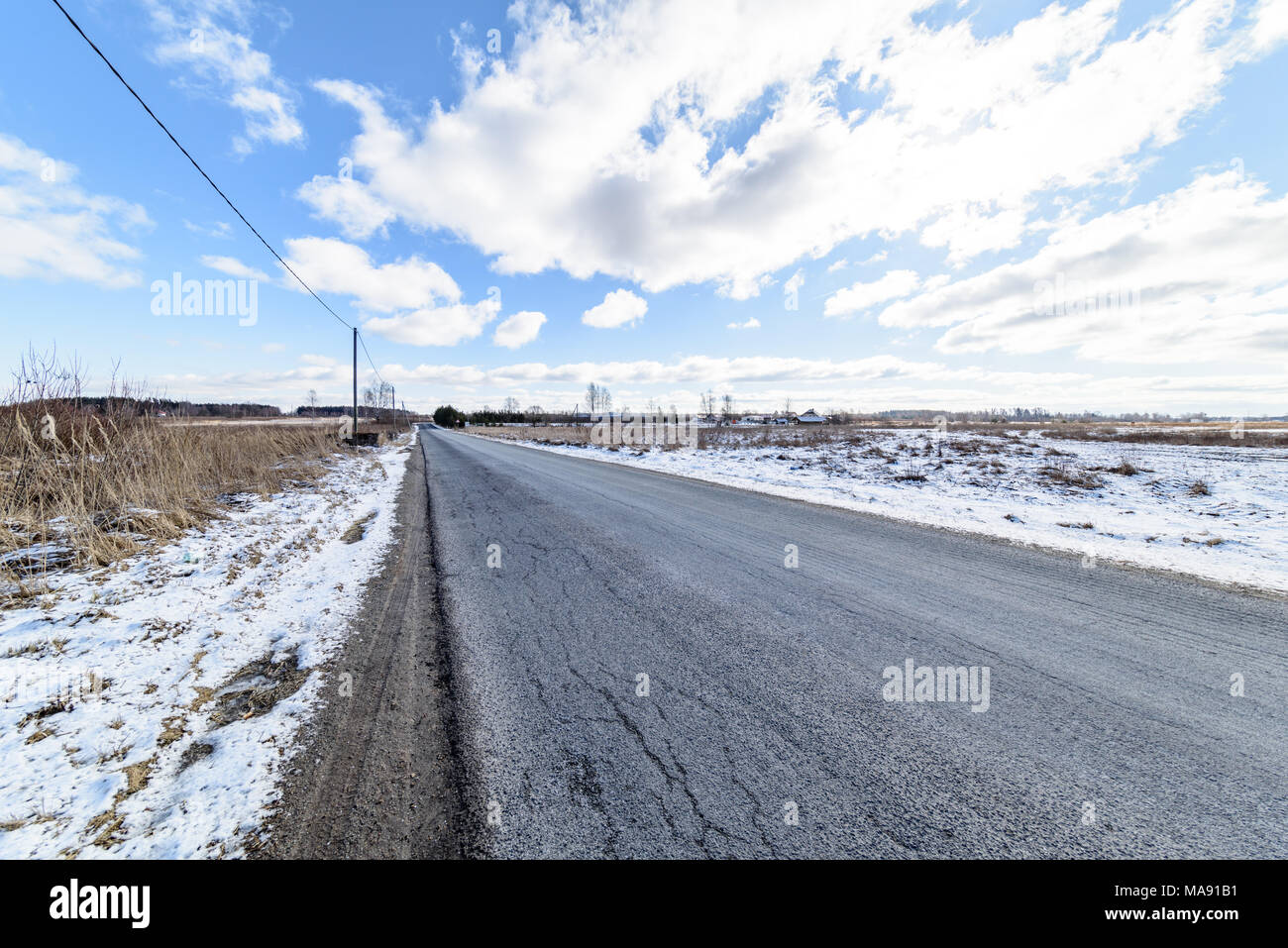 snowy winter road covered in deep snow with car tire tracks going in ...