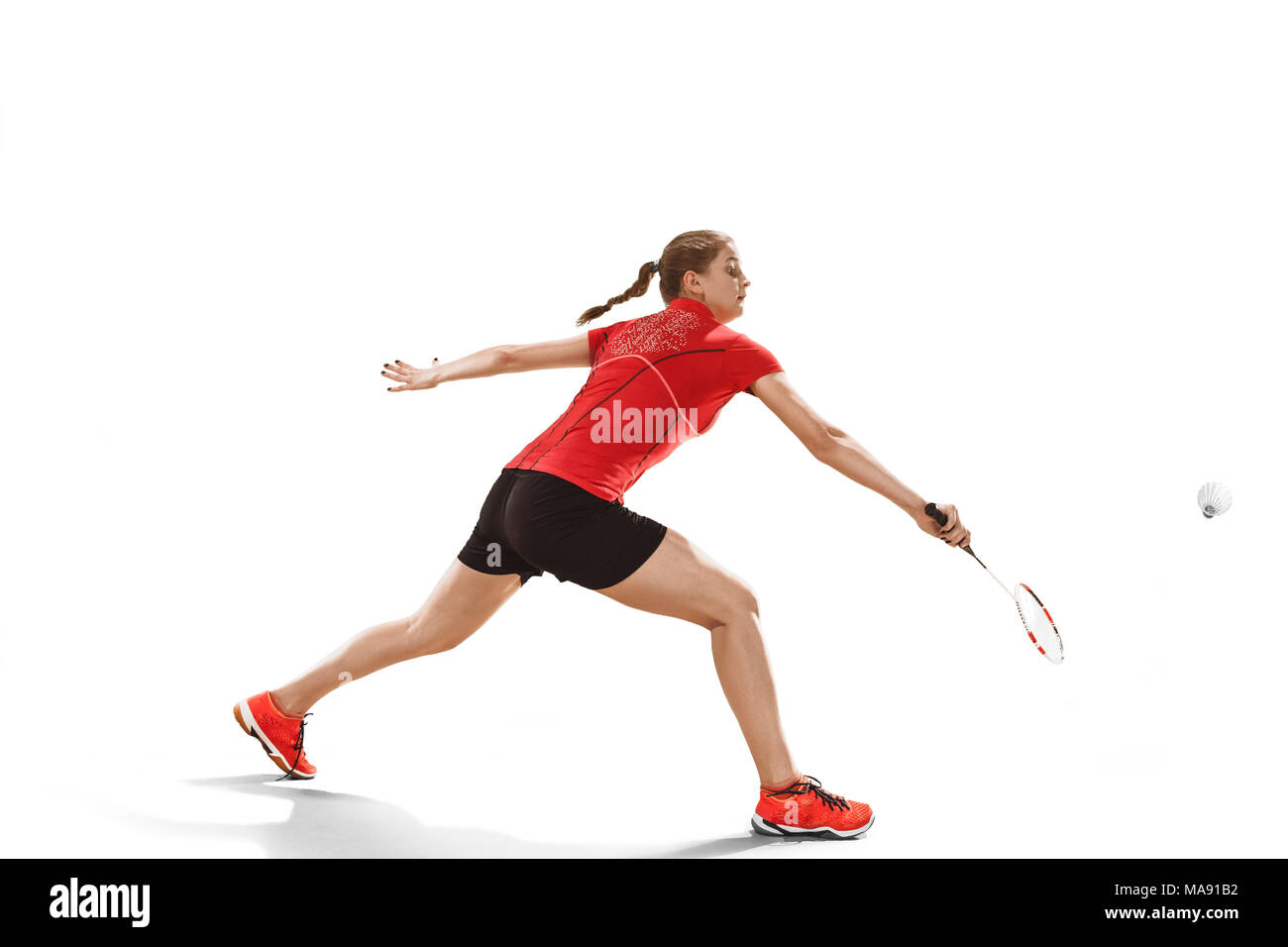 Young woman playing badminton over white background Stock Photo - Alamy