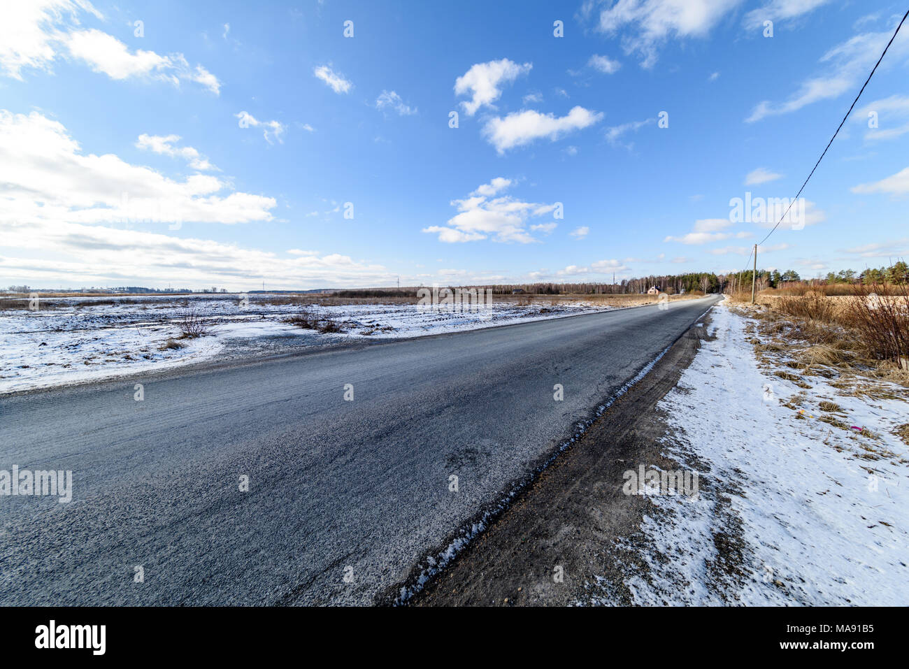 snowy winter road covered in deep snow with car tire tracks going in ...
