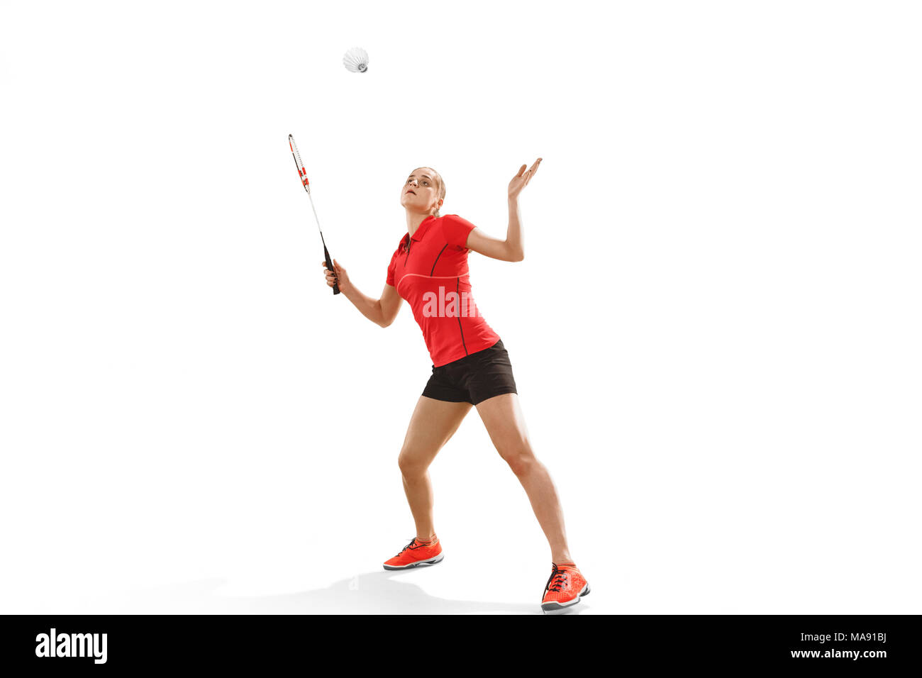 Young woman playing badminton over white background Stock Photo - Alamy
