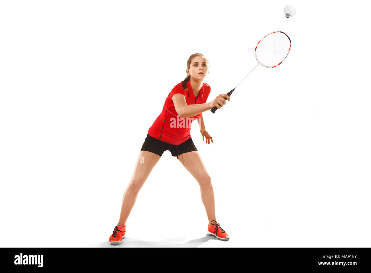 Young woman playing badminton over white background Stock Photo - Alamy