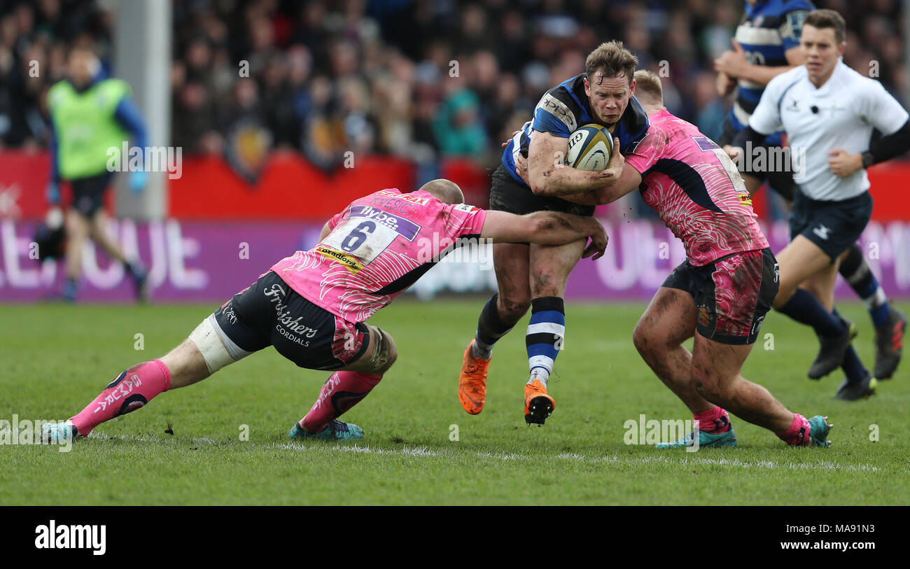 Bath's Chris Cook is tackled by Exeter's Matt Kvesic and Jack Innard ...
