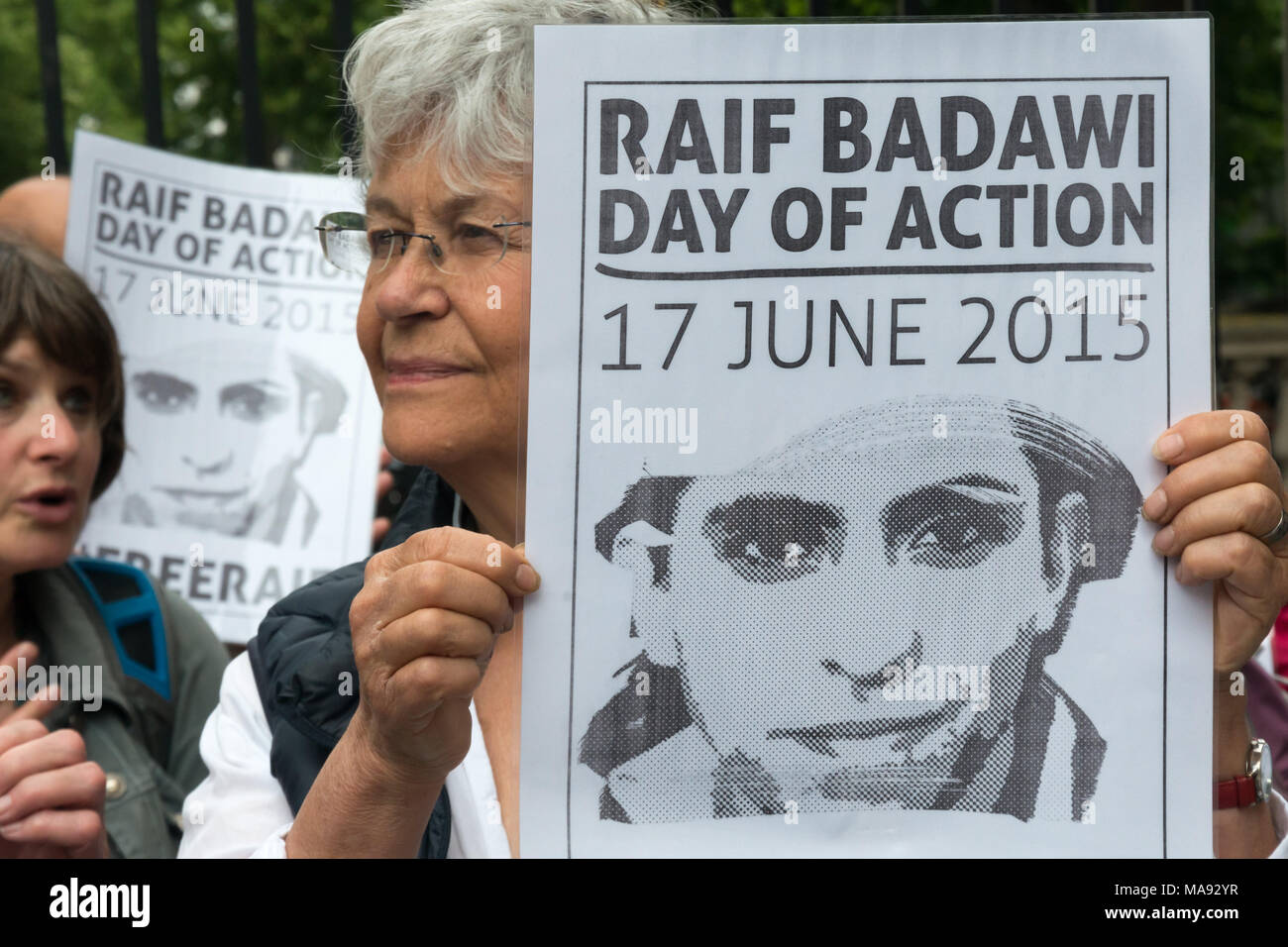 A woman holds up a poster at the letter hand-in to Downing St on Day of ...