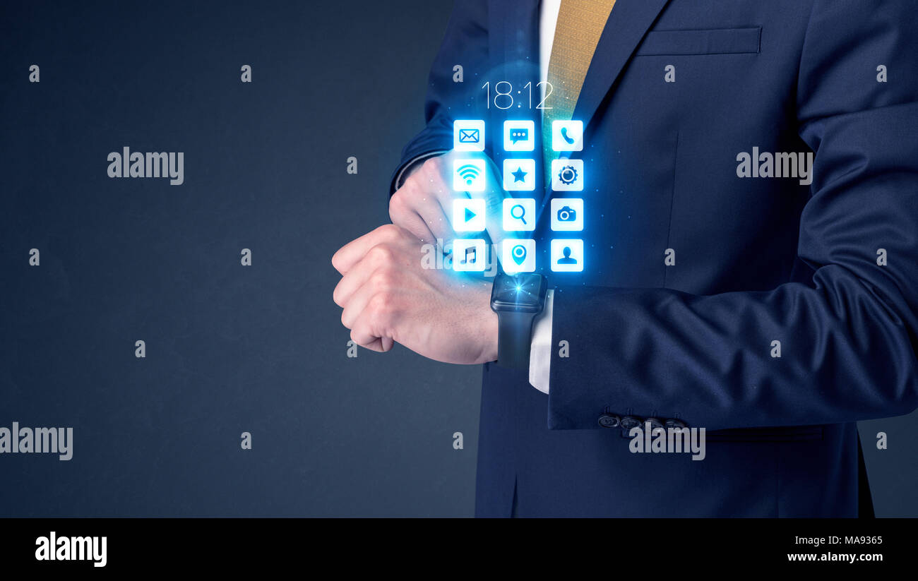 Businessman wearing smartwatch with application icons Stock Photo - Alamy