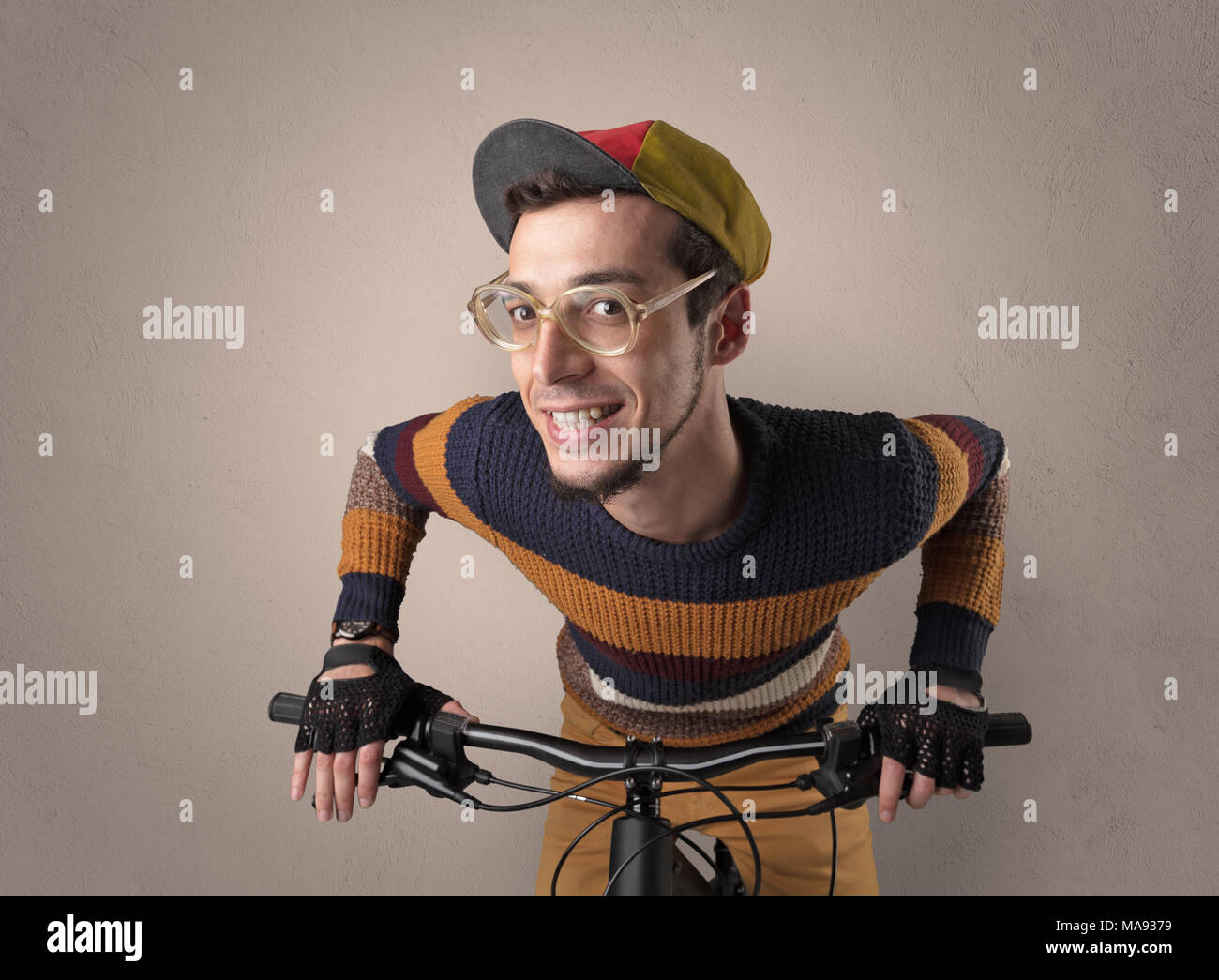 Nerd young foolish biker on a bike with oldschool outfit Stock Photo ...