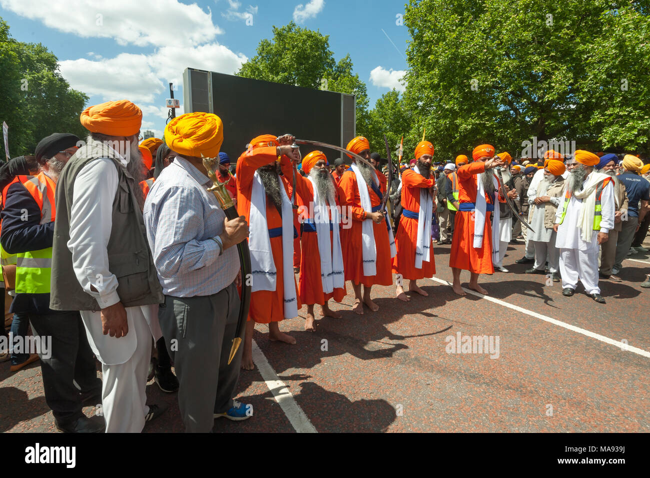 Five Khalsa representing the Blessed Ones draw their ceremonial swords ...