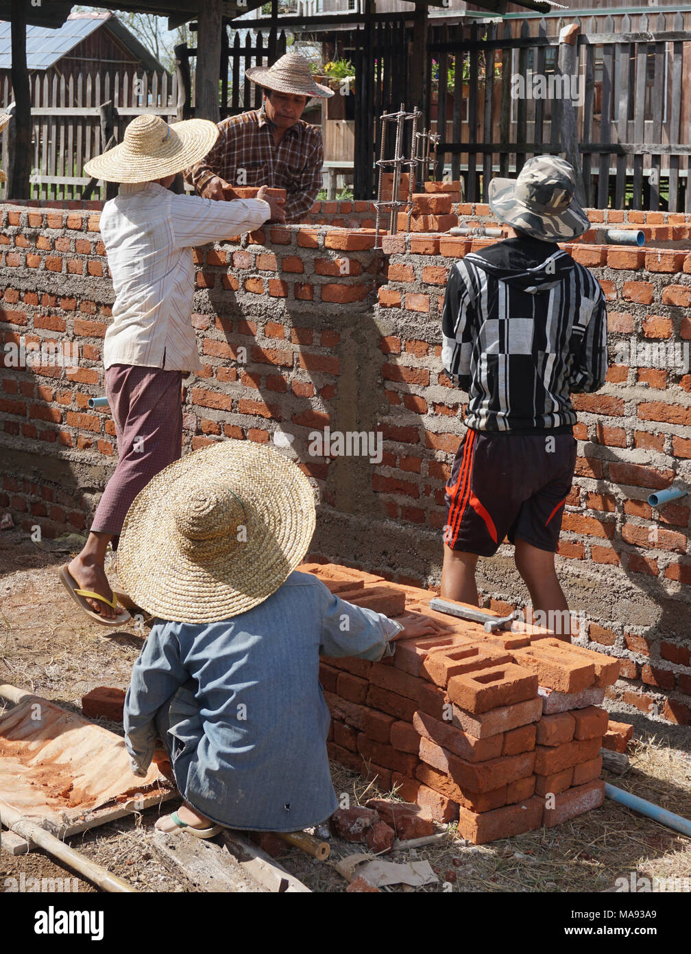 Bricklayers build a wall in a village on Inle lake, Shan State, Myanmar ...