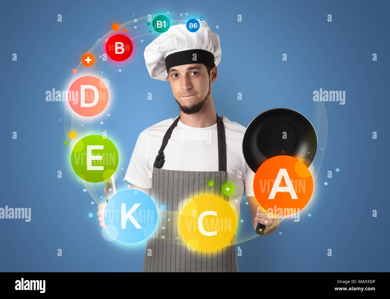 Handsome cook with kitchen instruments and vitamin concept Stock Photo ...