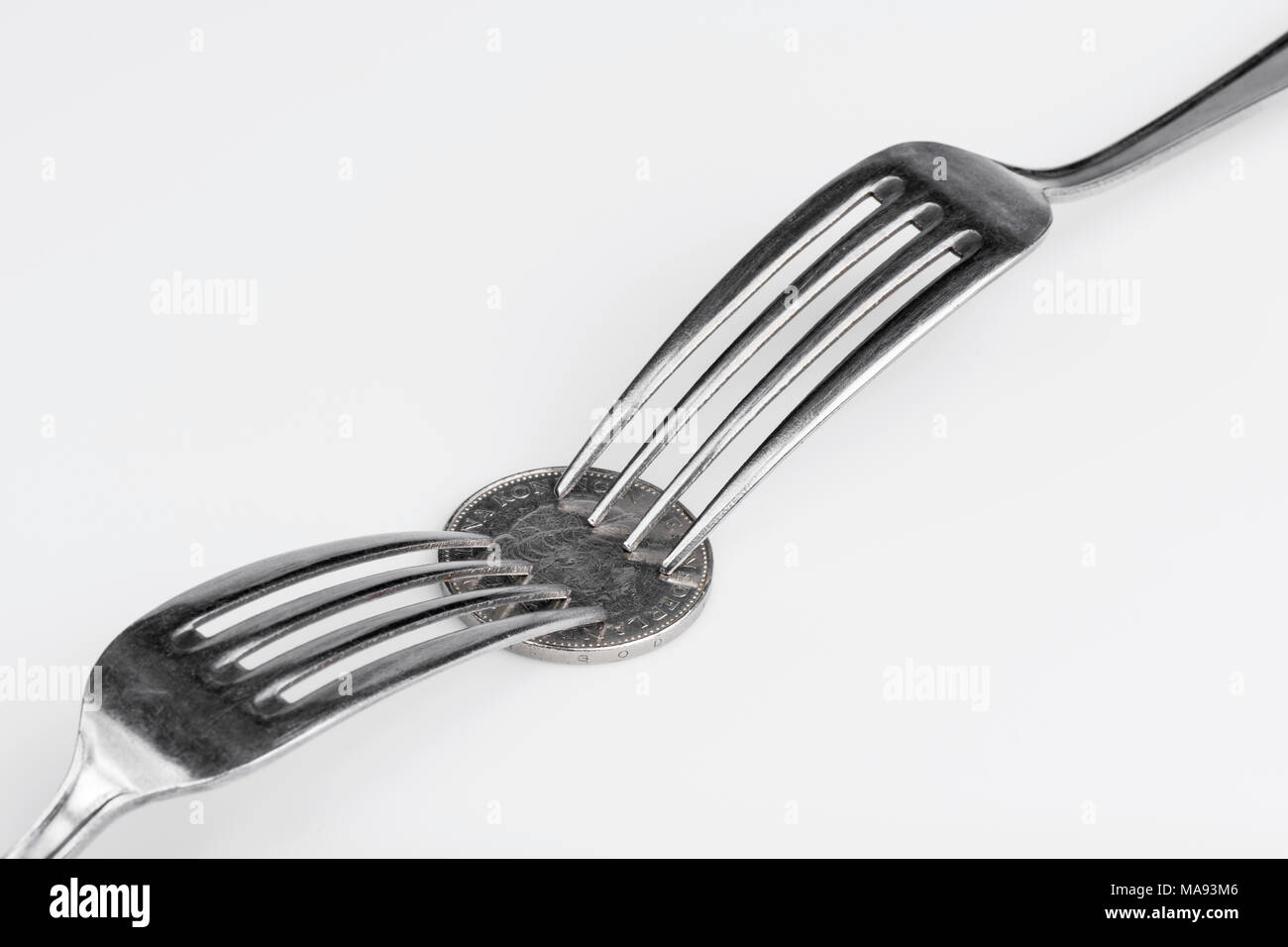 Conceptual representation of financial greed by two forks and coins ...