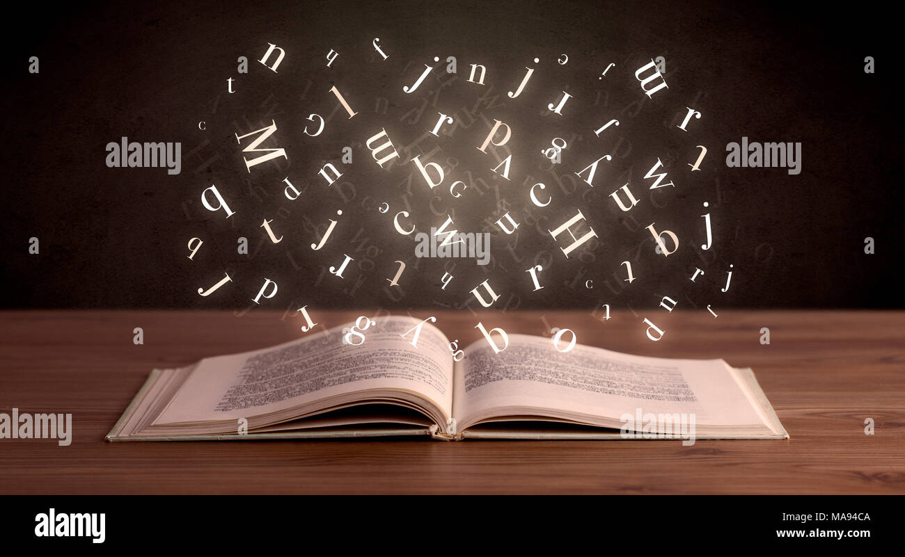 Glowing white alphabet letters coming out of an open book Stock Photo ...