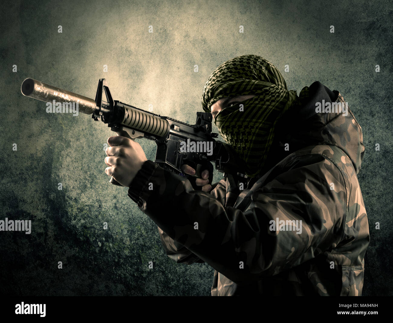 Portrait of a heavily armed masked soldier with grungy background ...