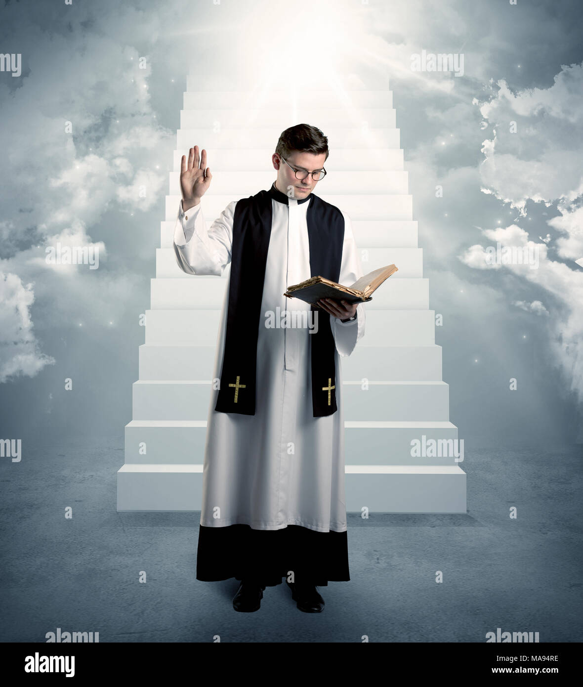 A young religious happy priest standing in front of the stairway to ...