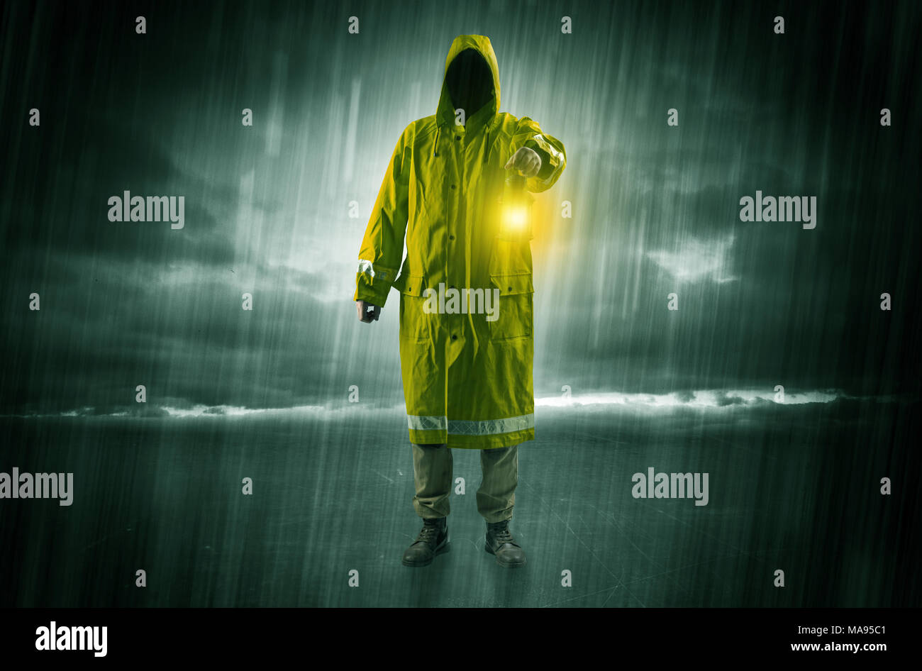 Raincoated man walking in storm with glowing lantern in his hand Stock ...