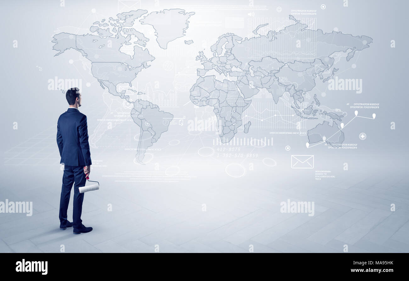 Businessman standing with his back and looking at a worldwide map with ...