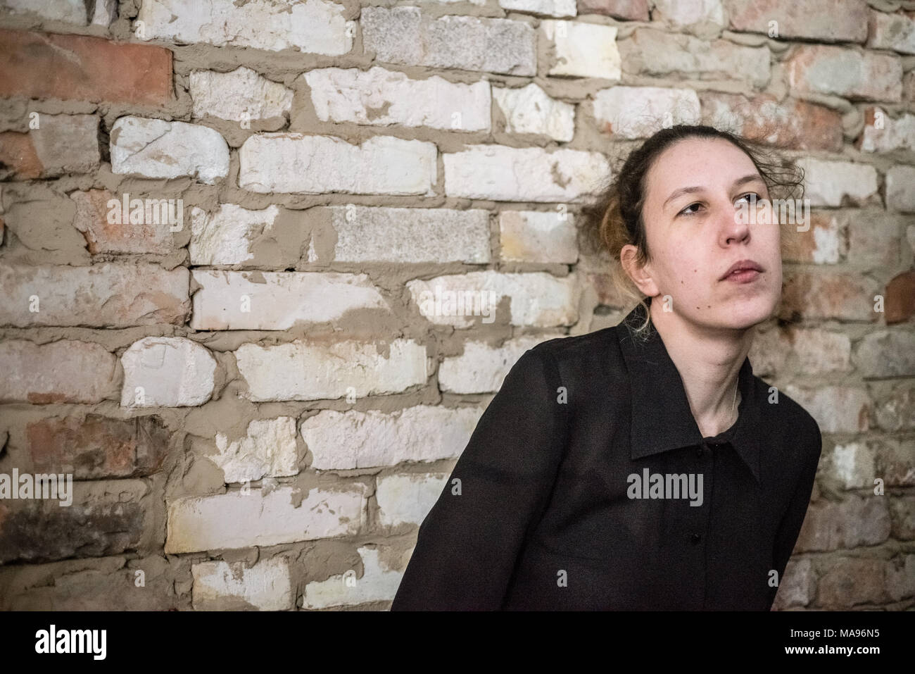 Portrait of a woman in front of a wall Stock Photo - Alamy