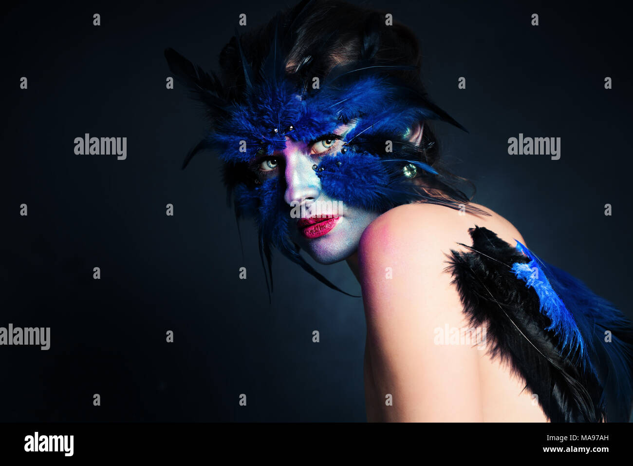 Halloween Makeup. Fantasy Bird Woman with Artistic Make-up on Blue ...