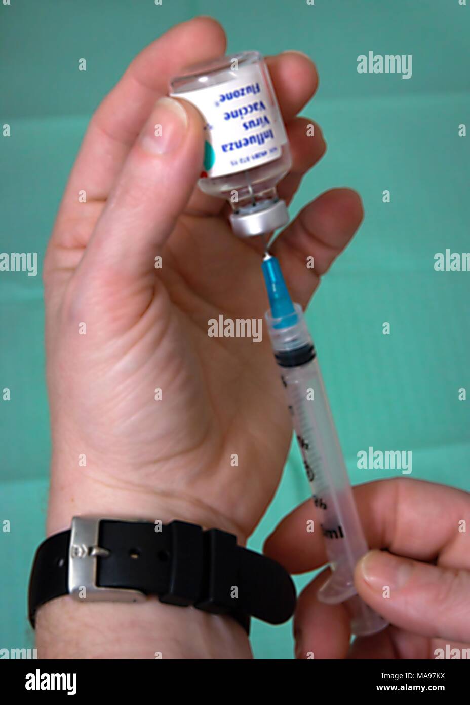 Filling a syringe with the Influenza Virus Vaccine Fluzone, close-up ...