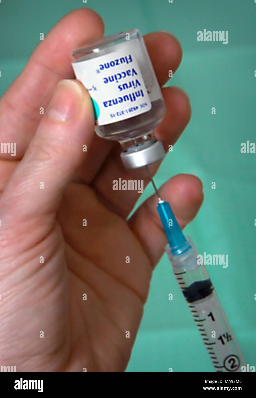 Filling a syringe with the Influenza Virus Vaccine Fluzone, close-up ...