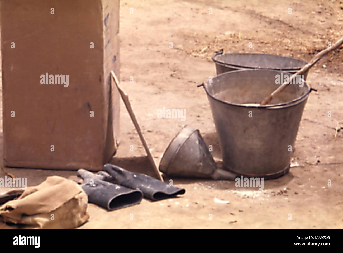 Photograph of a bucket, funnel, work gloves and various other objects ...