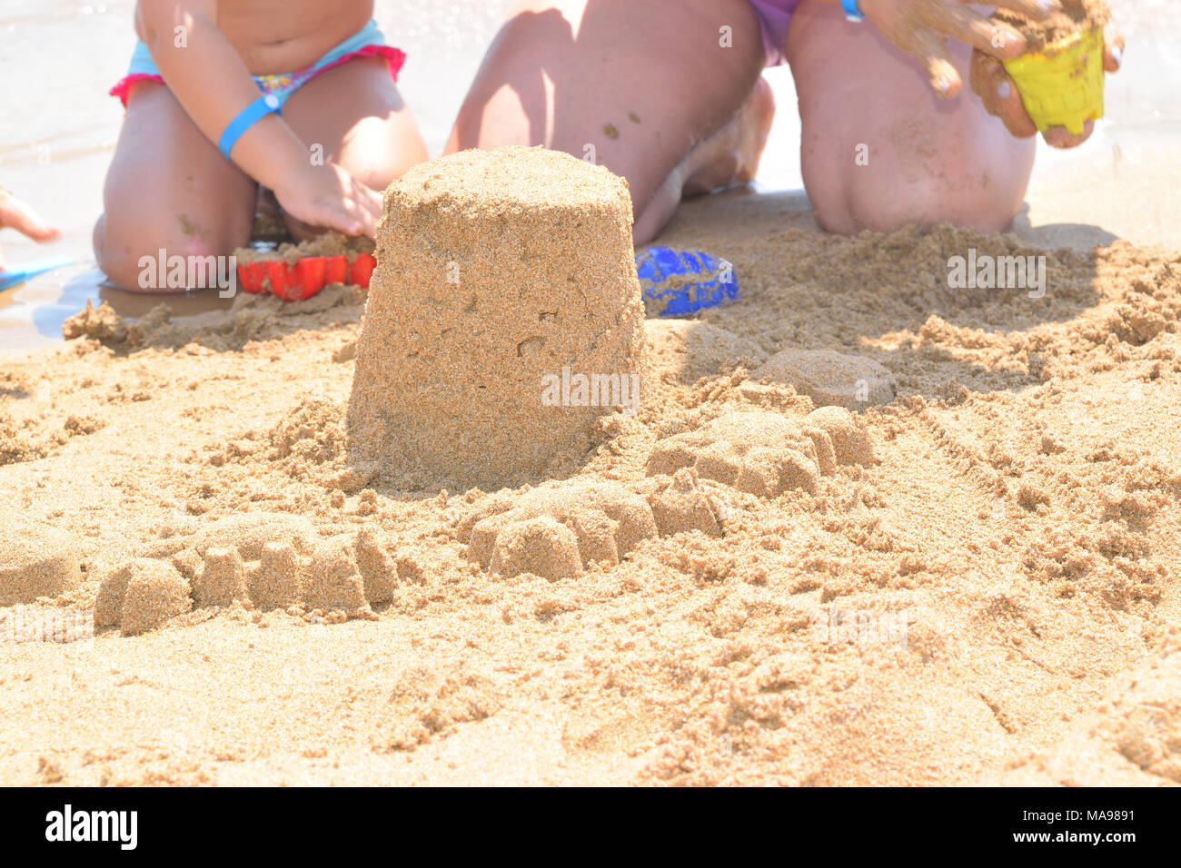 building a sand castle on the beach Stock Photo - Alamy