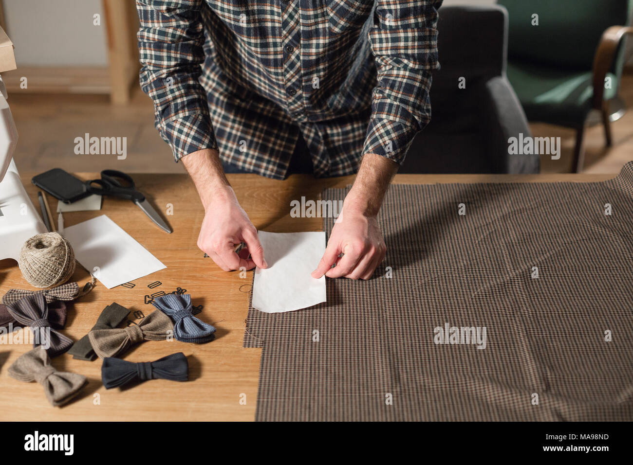 Cutting wool fabric. the line pattern. Bow ties of woolen fabric. Young ...