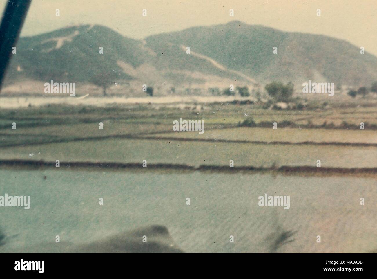 Color photograph, shot from inside a vehicle, showing a flat expanse of ...