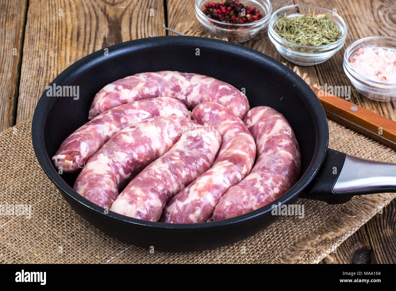 Sausage raw rustic in the pan. Studio Photo Stock Photo - Alamy
