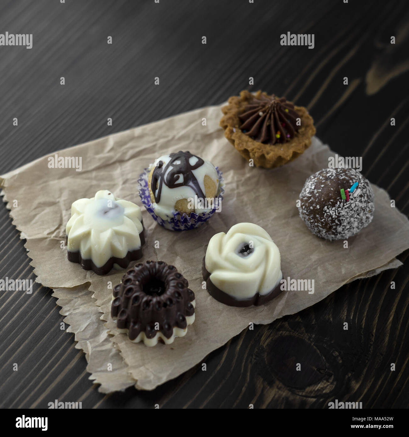 Different kinds of beautiful pastry, small colorful sweet cakes, close ...