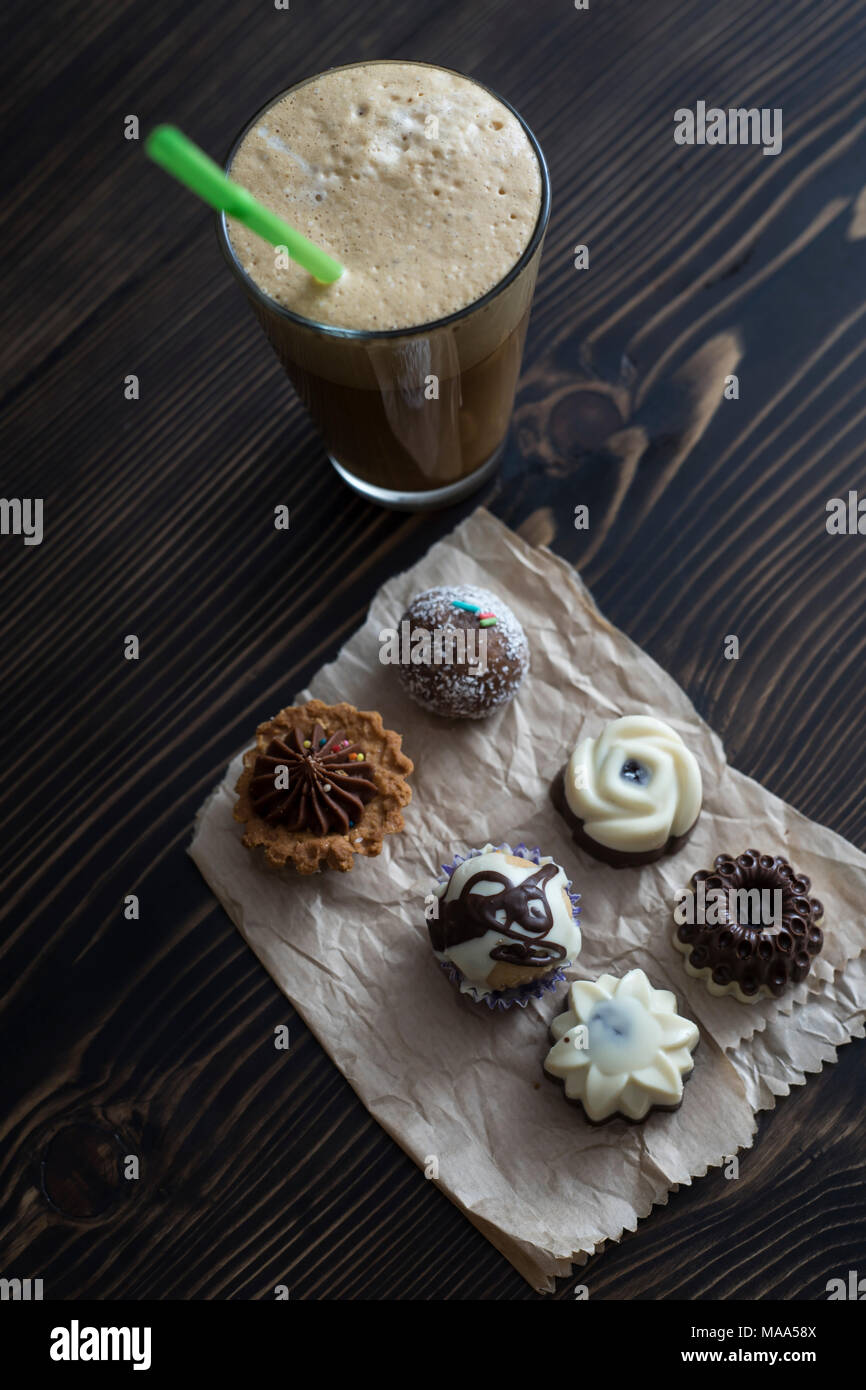 Coffee and small colorful sweet cakes, from above Stock Photo - Alamy