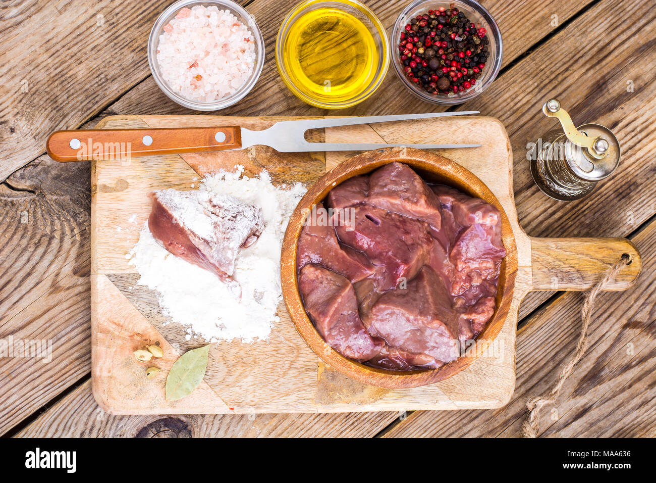 Liver cut into pieces for frying, wooden background. Studio Photo Stock ...