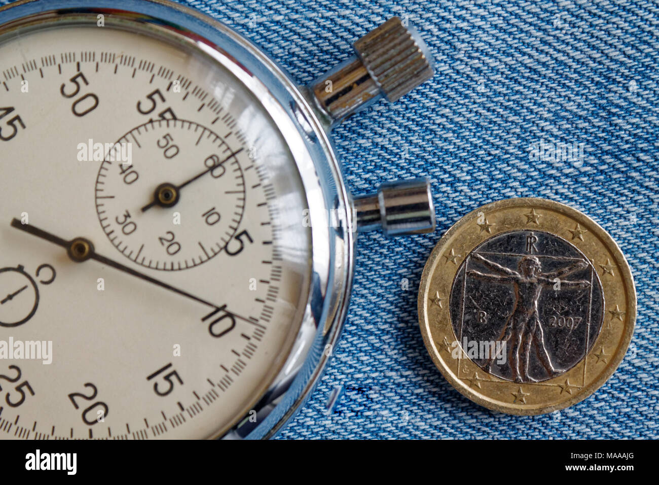 Euro coin with a denomination of 1 euro (back side) and stopwatch on ...