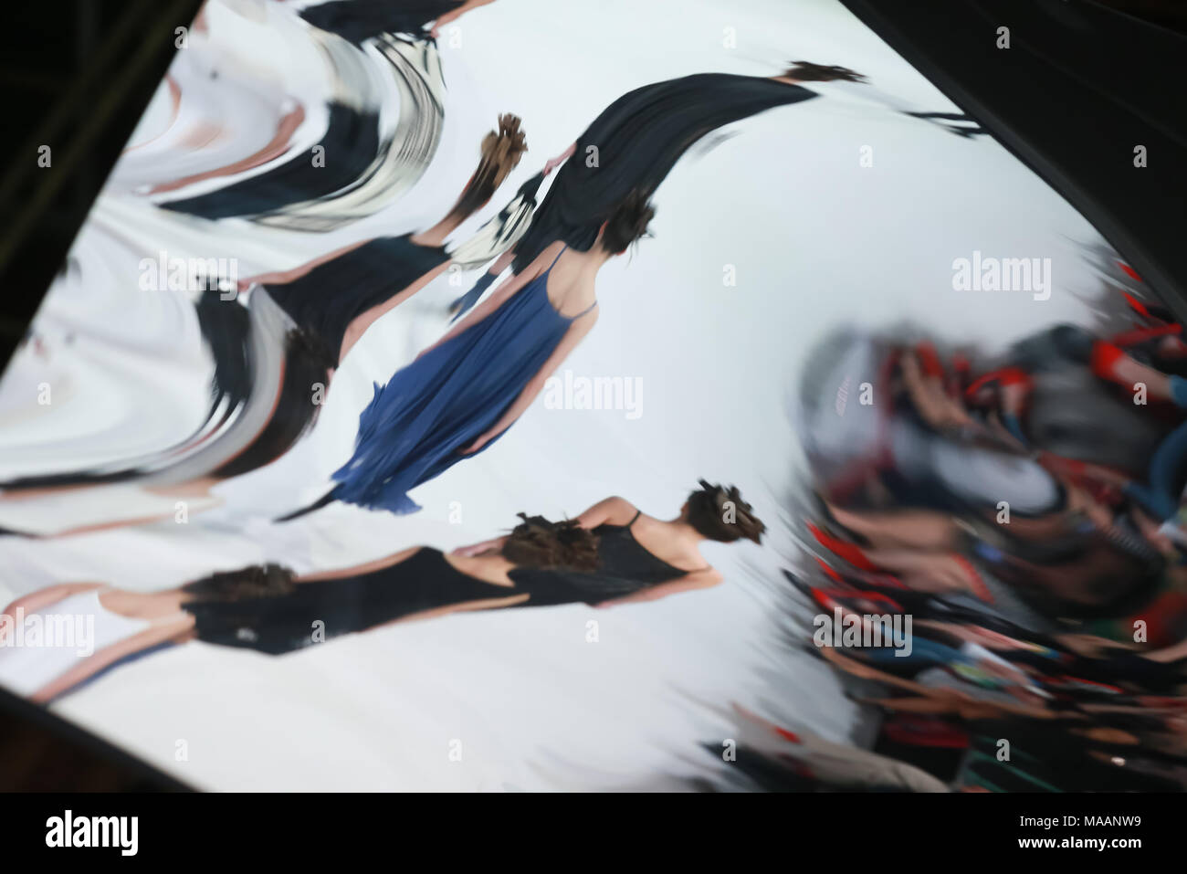 Abstract view on the mirror of the fashion model walking down the ...