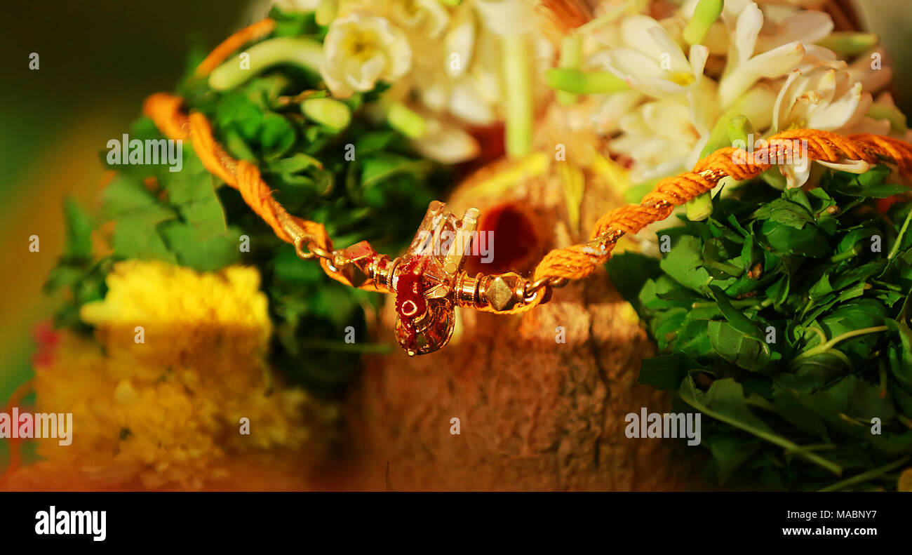 South Indian thaali wrapped around coconut and decorated with garland ...