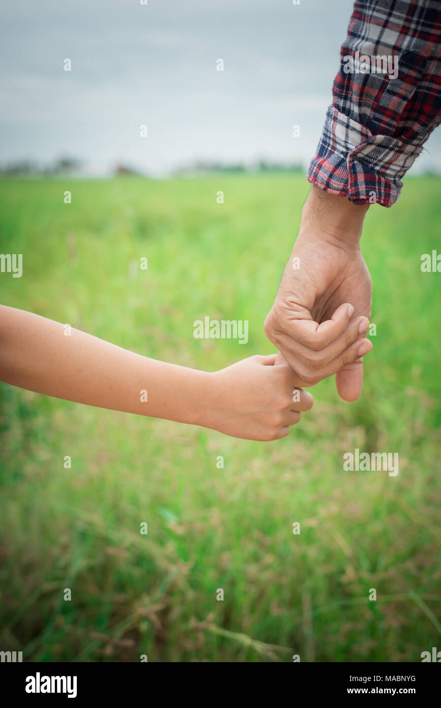 Close up of father holding his daughter hand, so sweet,family time Stock Photo - Alamy