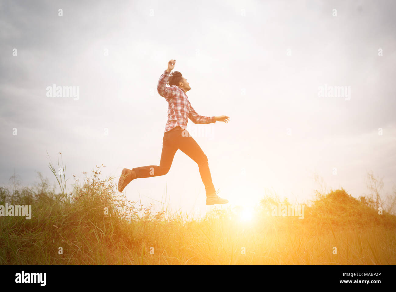 Hipster man jump up high, Freedom enjoying with the nature around Stock ...