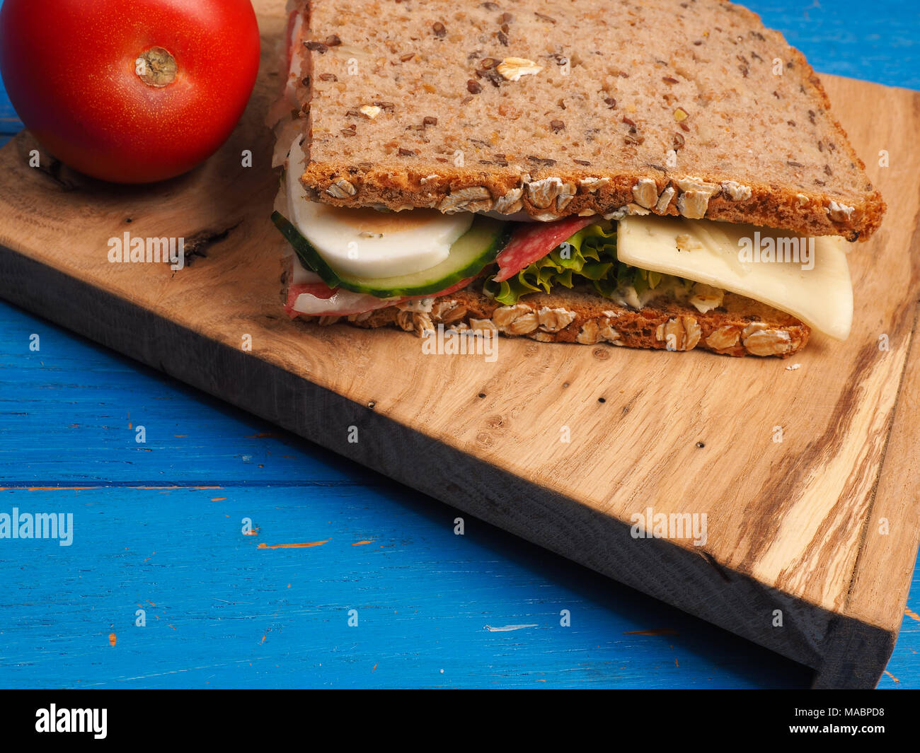 Tasty whole grain sandwich on a blue kitchen table, healthy eating ...