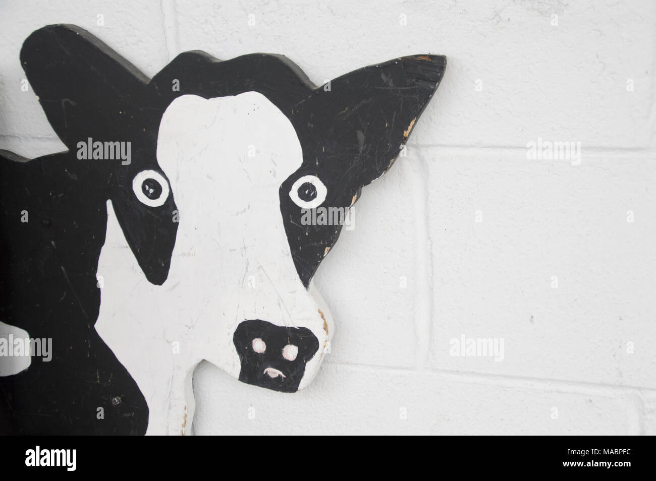 Painted sign of a dairy cow on the wall of Silvana Meats,in Silvan ...
