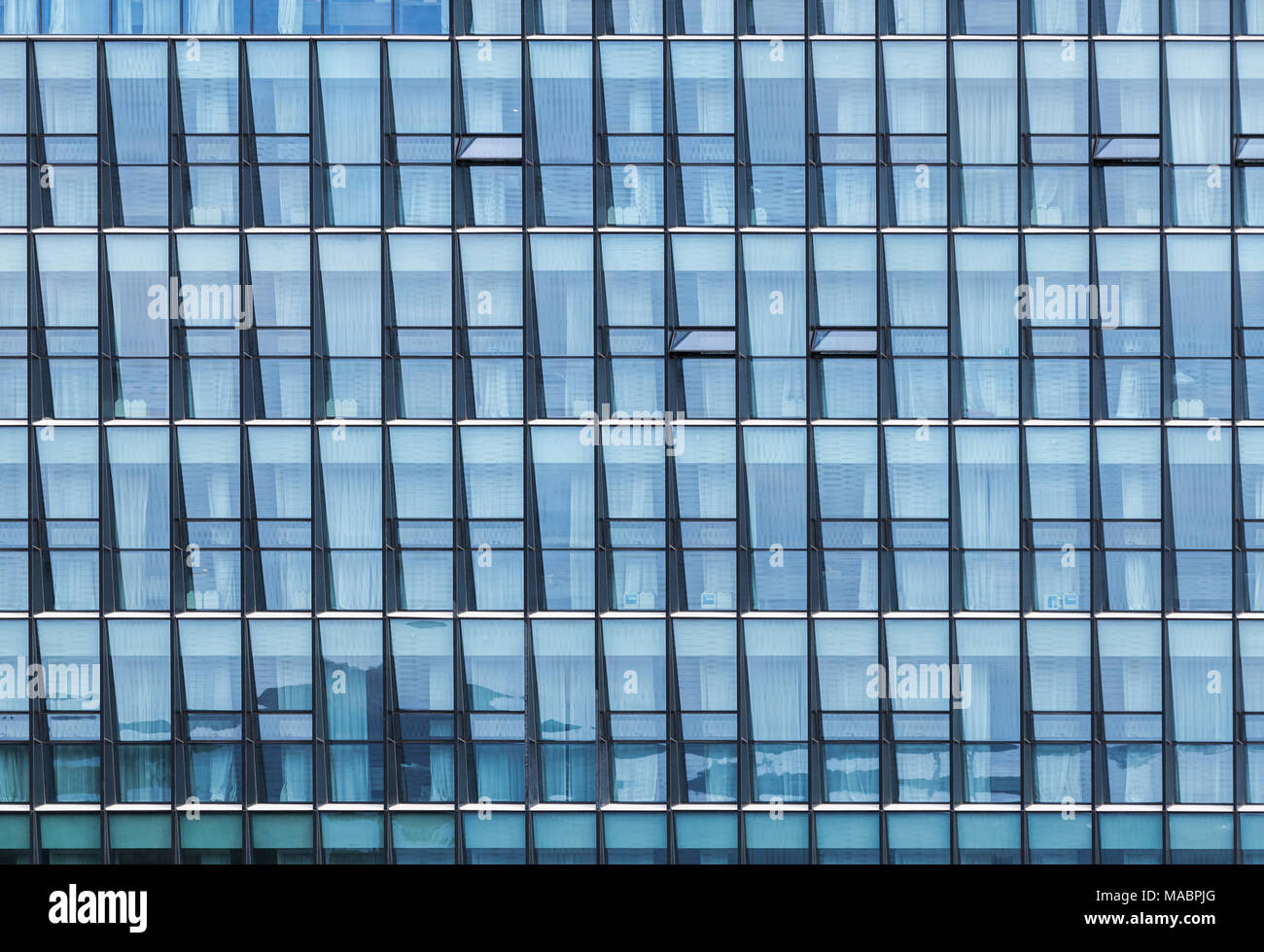 Modern office building facade with windows, blue toned glass and steel ...