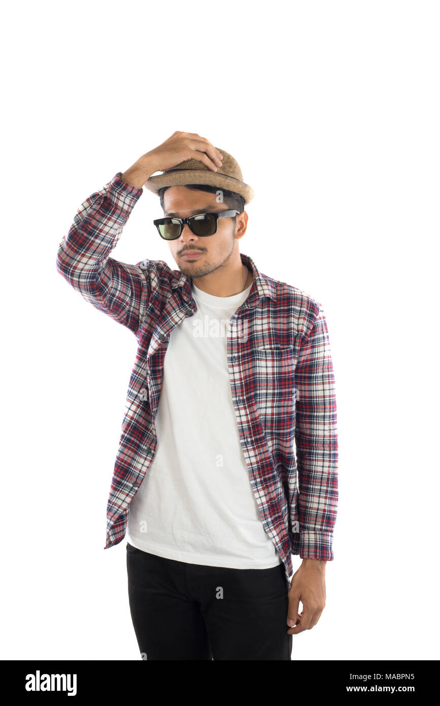 Portrait of young hipster man adjusting hat with head at camera on ...