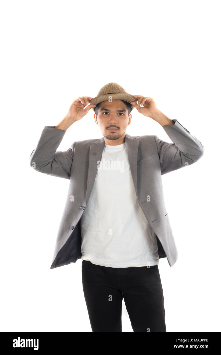 Portrait of young hipster man adjusting hat with head at camera on ...