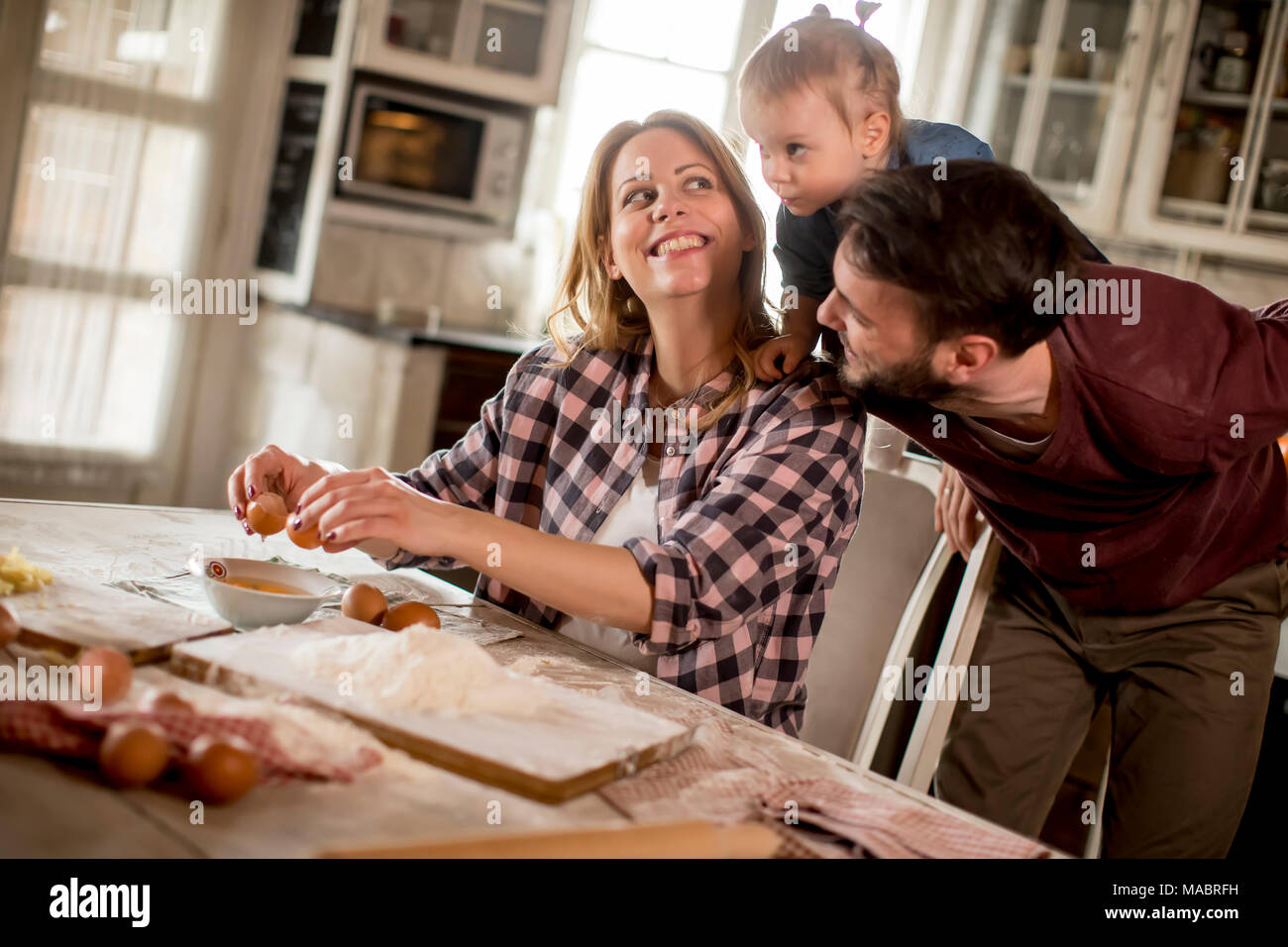 Happy family making pasta in the kitchen at home Stock Photo - Alamy